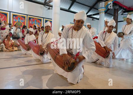 Hindu monks (bhaktis) drumming and dancing Uttar Kamalabari Satra (monastery) on Majuli Island ...
