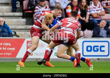 Wigan Warriors' Jake Wardle is tackled by Leeds Rhinos' James McDonnell ...