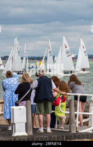 cowes week spectators. tourists and yachtsmen spectating at the royal ...