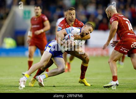 Warrington Wolves Matt Dufty is tackled by a defender during the Super ...