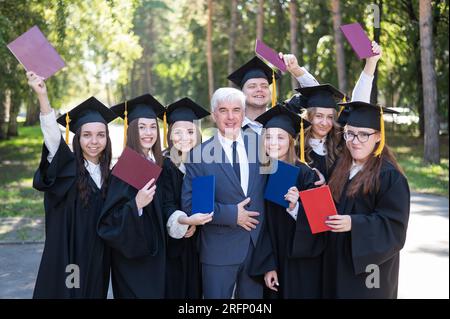 University professor and seven graduates rejoice at graduation Stock ...