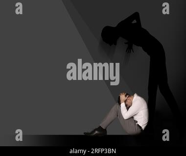 Suffering from hallucinations. Scared man closing eyes because of ...