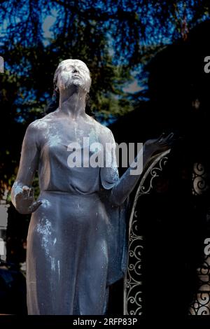 Milan cemetery statue looking up Stock Photo - Alamy