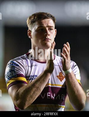 Sam Halsall #24 of Huddersfield Giants attempts to tackle Sam Lisone ...