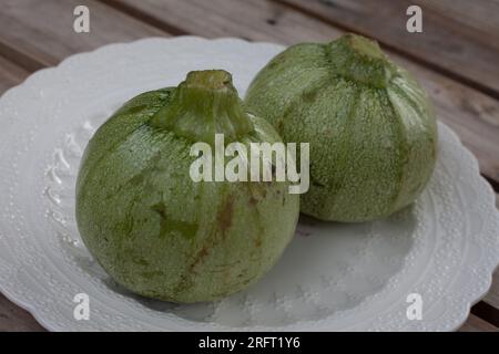 An almost matching pair of globular round courgettes - comedy fruit and ...