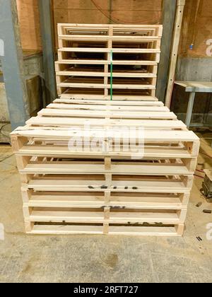 Stacks of wood pallets in a factory Stock Photo - Alamy