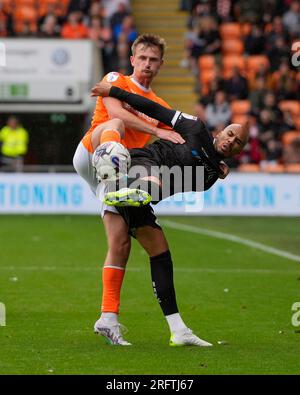 Callum Connolly #2 of Blackpool competes for the ball with Sonny Carey ...
