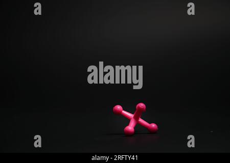 Plastic toy of molecule elements background, pink pastic atom structure ...