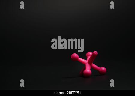 Plastic toy of molecule elements background, pink pastic atom structure ...