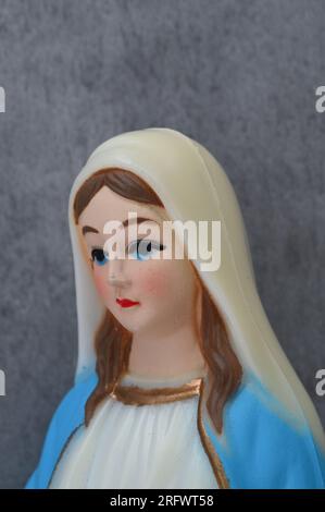Model of Virgin Mary with big blue eyes looking sad and wearing blue ...