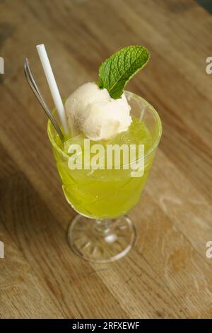 An alcoholic cocktail with a scoop of ice cream on a table Stock Photo ...