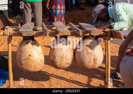 Skilled craftsman tune a traditional wooden xylophone-like instrument ...