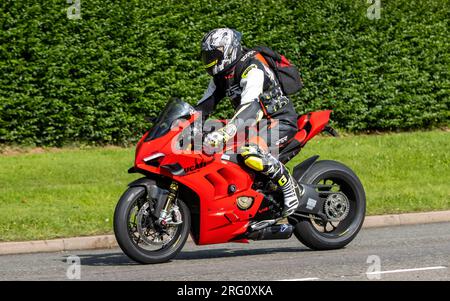 Man in black riding a Ducati motorcycle Stock Photo - Alamy
