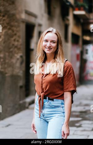 Young blonde woman tourist smiling confident using smartphone at coffee ...