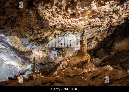 Cave dark interior with light, stalactites and stalagmites Stock Photo ...