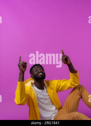 Excited Guy Pointing Fingers Up Standing On Orange Background, Studio ...