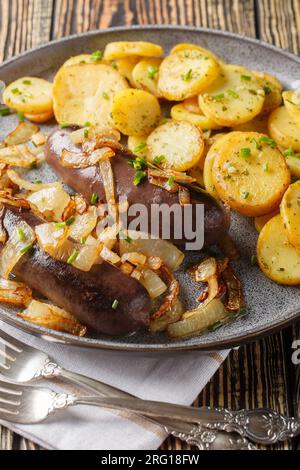 Fried blood sausage with potatoes served at plate Stock Photo - Alamy