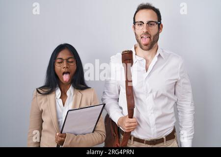 Interracial business couple wearing glasses with hand on chin thinking ...