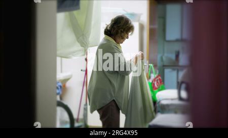 Efficient and Independent Senior Lady Tackles Household Chores in Her ...