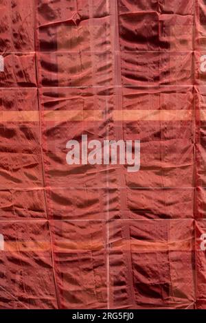 Colourful sheets of protective textile covers attached to the ...