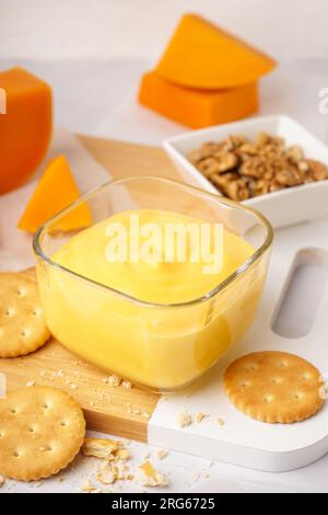 Bowls with tasty crackers on grunge background Stock Photo - Alamy