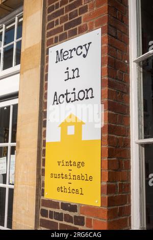 Mercy in Action Charity shop sign Stock Photo - Alamy
