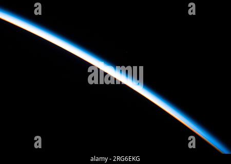 The first rays of an orbital sunrise illuminates the Earth's limb and ...