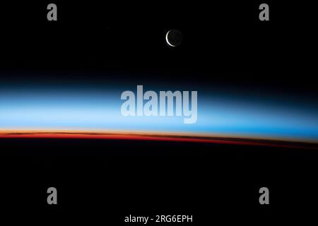 An image of the crescent moon with Earth's atmosphere, captured by the ...