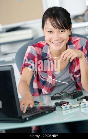 happy female electronic engineer soldering computer motherboard in ...