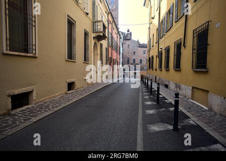Descending street between historical buildings in an italian town at ...