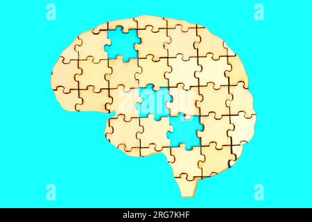 Close-up of an incomplete human brain shape jigsaw puzzle with three ...