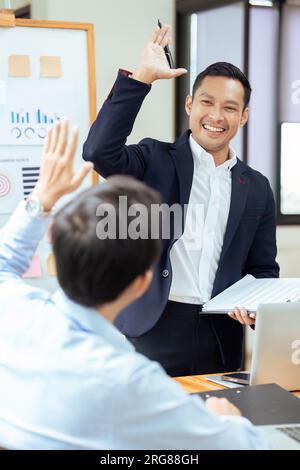 Businesspeople smile and high five , feeling celebrate after project or ...