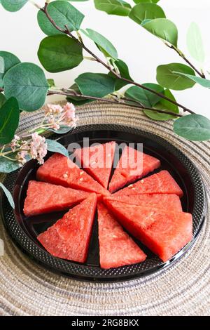 fresh watermelon slices arranged on serving plate with vibrant red ...