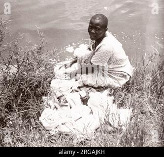 Portrait of an African woman washing clothes by hand in buckets. Accra ...
