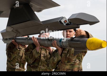 An Air Force Missile Maintenance Airman tighten bolts on the upper ...