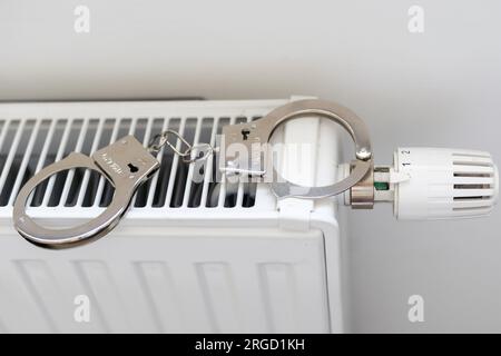 Handcuffs on the radiator. Police handcuffs and collar Stock Photo - Alamy