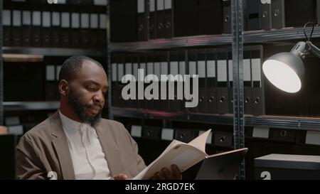 Police investigator examining clues from crime scene, looking at ...