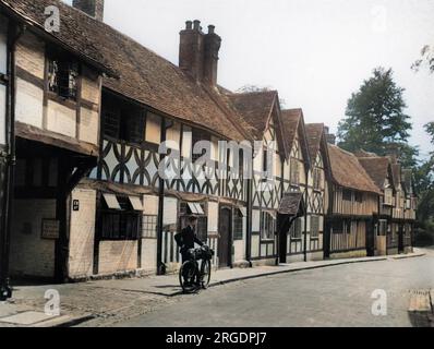 Mill Street, Warwick, with a row of Tudor half-timbered houses, a ...