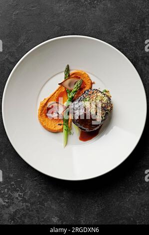 Slow-cooked beef cheek, charred shallots, asparagus spears, romesco ...