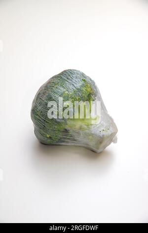 An Isolated broccoli wrapped into plastic Stock Photo - Alamy