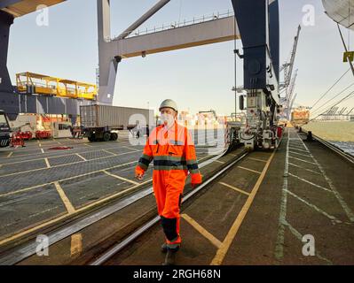 Dock worker in orange jumpsuit at Port of Felixstowe, England Stock ...