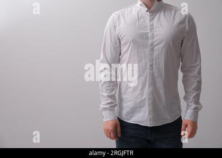 Man wearing rumpled shirt on white background, back view Stock Photo ...
