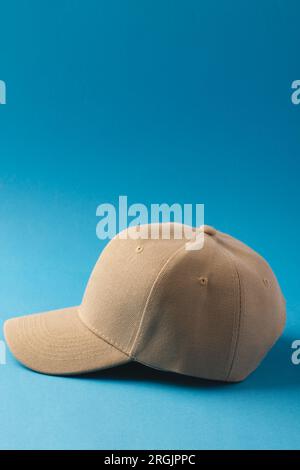 Cream baseball cap and copy space on blue background Stock Photo - Alamy