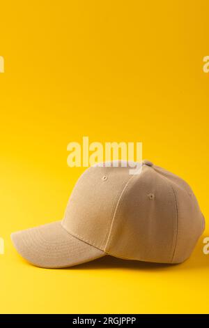 Cream baseball cap and copy space on yellow background Stock Photo - Alamy