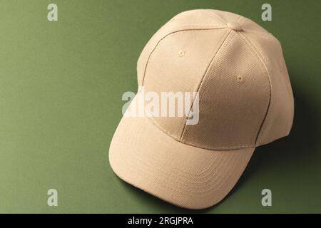 Cream baseball cap and copy space on green background Stock Photo - Alamy