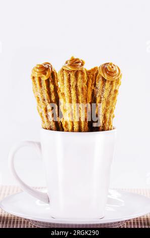 churros in a mug, traditional fried sweet from Latin America, Brazil ...