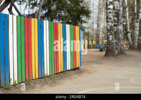 Colored fence in garden. Children's fence. Colorful board. Fun yard ...