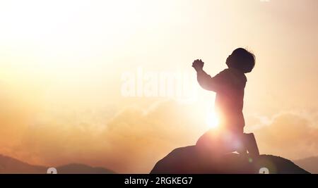 Jesus Christ praying to god with sunlight background Stock Photo - Alamy