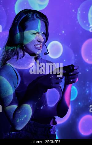 Nervous angry young woman gamer playing online computer games at the ...