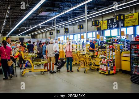 Long line up at a supermarket checkout line, view from the back Stock ...